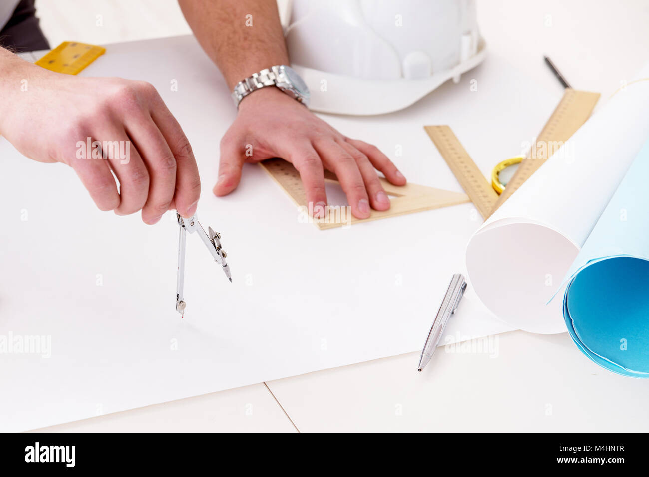 Male engineer working on drawings and blueprints Stock Photo - Alamy