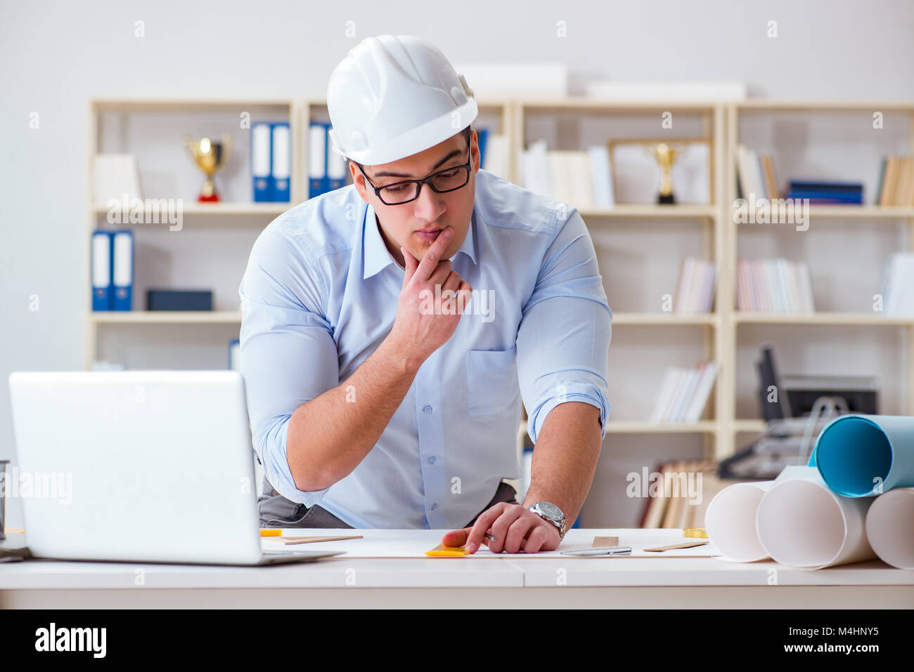 Male engineer working on drawings and blueprints Stock Photo - Alamy