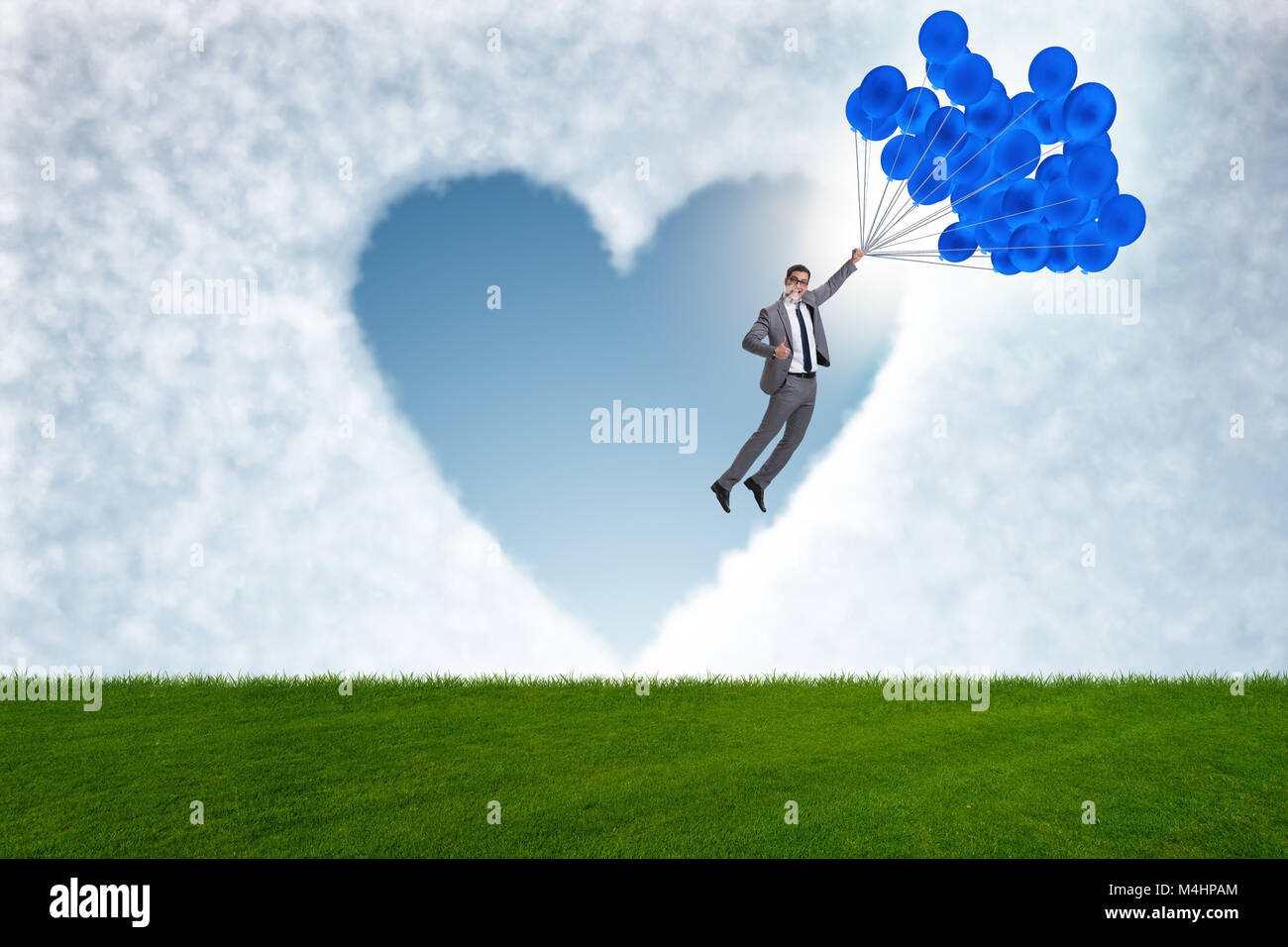 Man flying balloons in romantic concept Stock Photo - Alamy