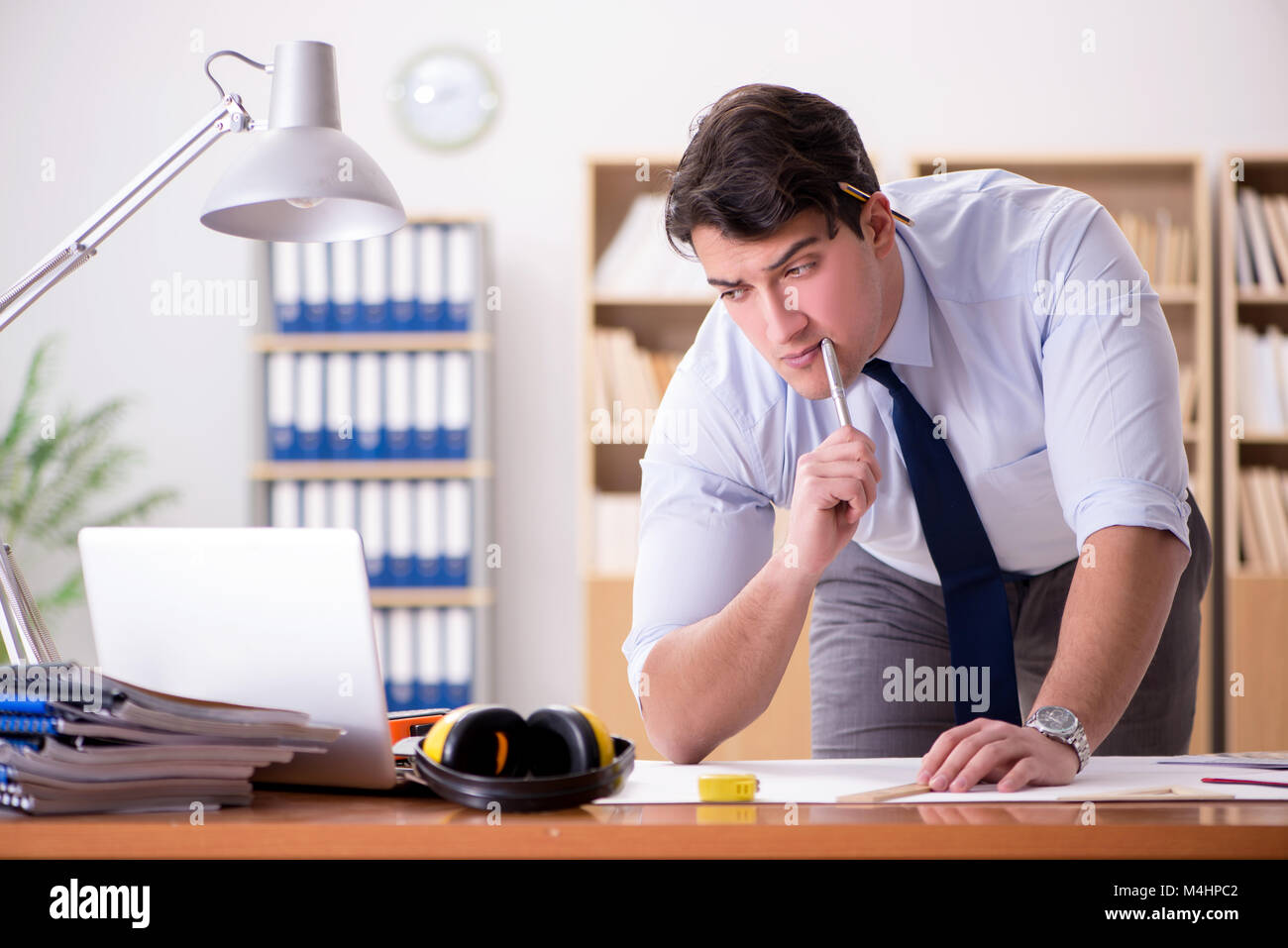 Engineer supervisor working on drawings in the office Stock Photo - Alamy