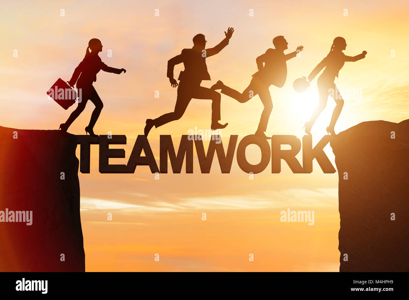 Teamwork concept with business people crossing bridge Stock Photo - Alamy