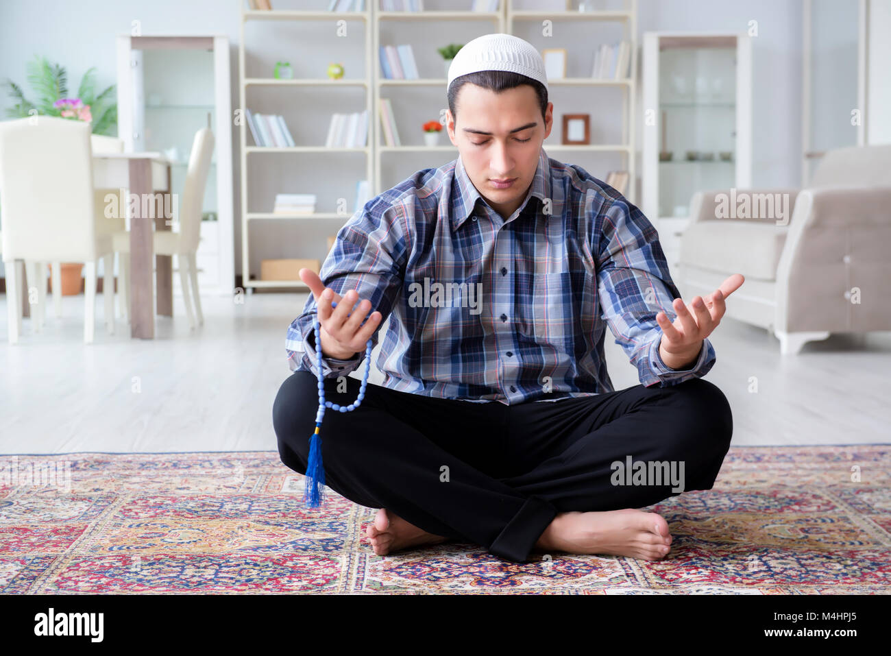 Muslim man praying at home Stock Photo - Alamy