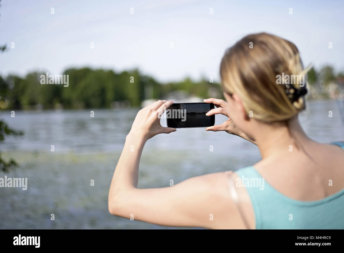 woman photographing with smartphone Stock Photo - Alamy