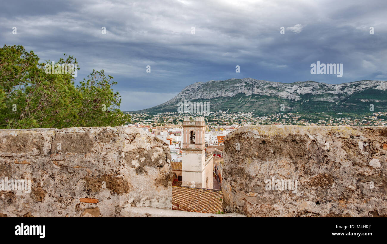 Denia church bellfry and montgo mountain Stock Photo - Alamy