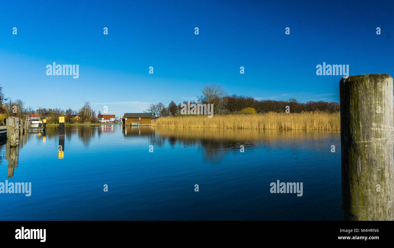 still river with boathouses Stock Photo - Alamy