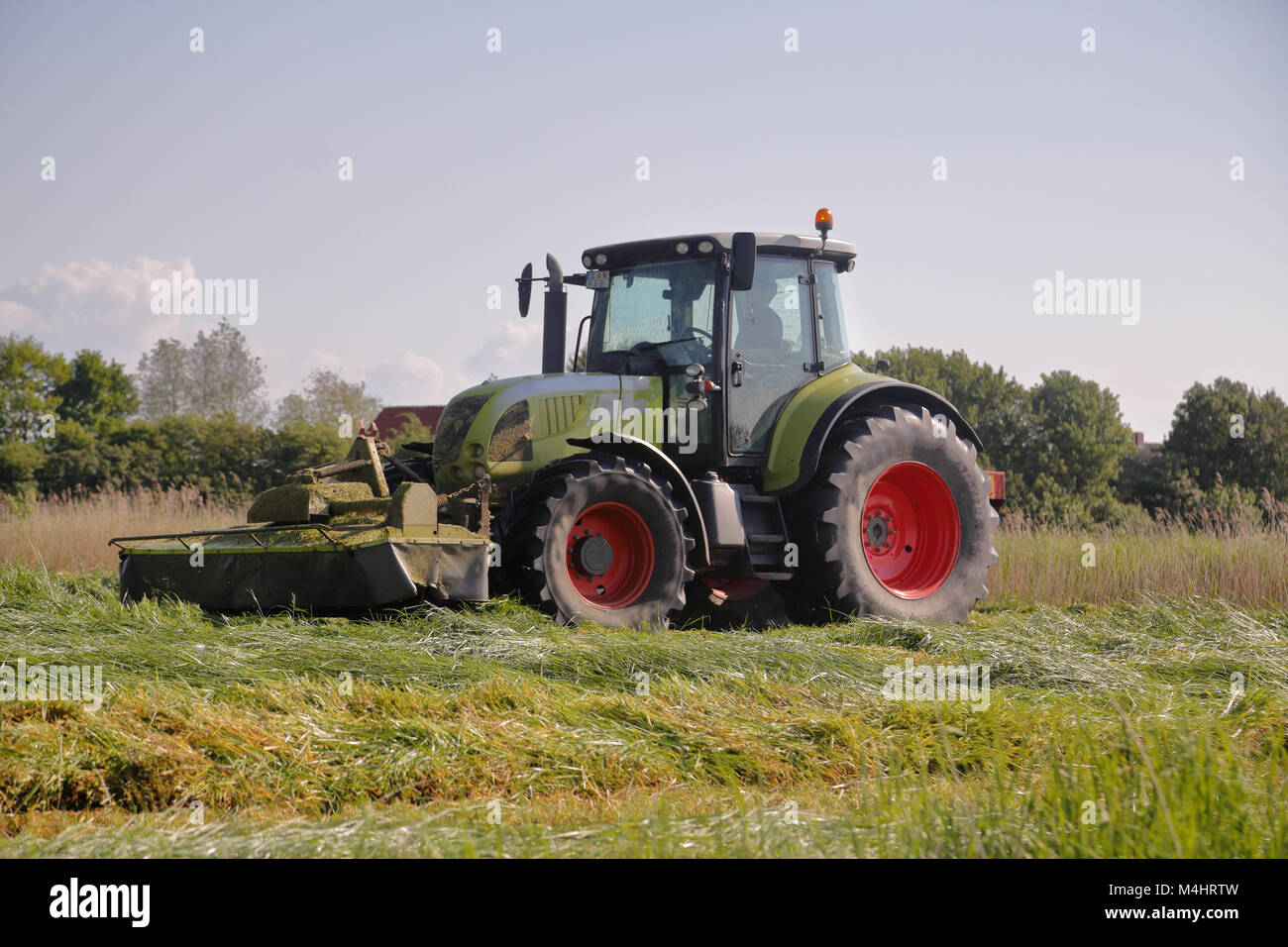 A tractor at the haymaking Stock Photo - Alamy
