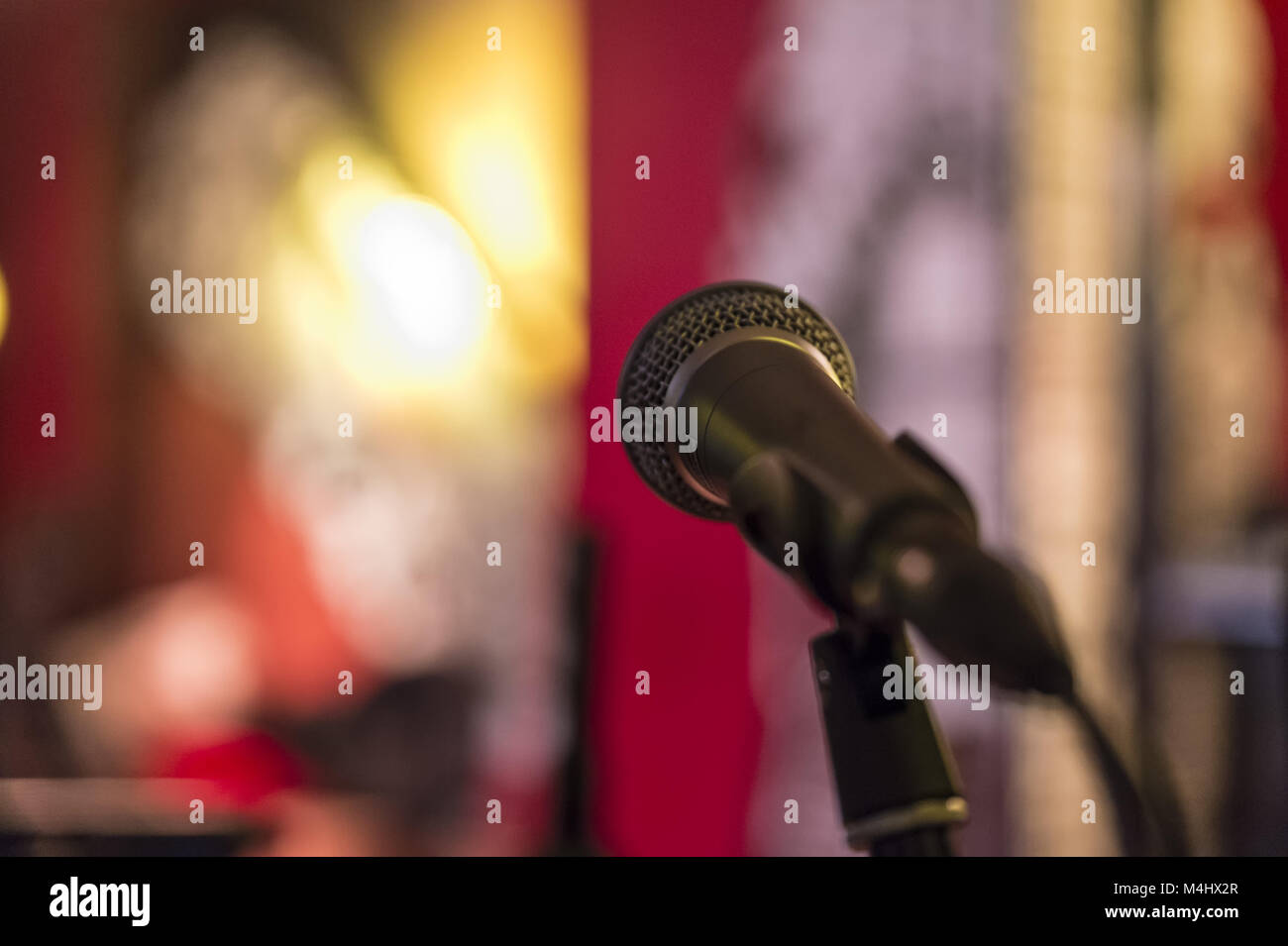 Closeup of a microphone in front of blurred background Stock Photo - Alamy