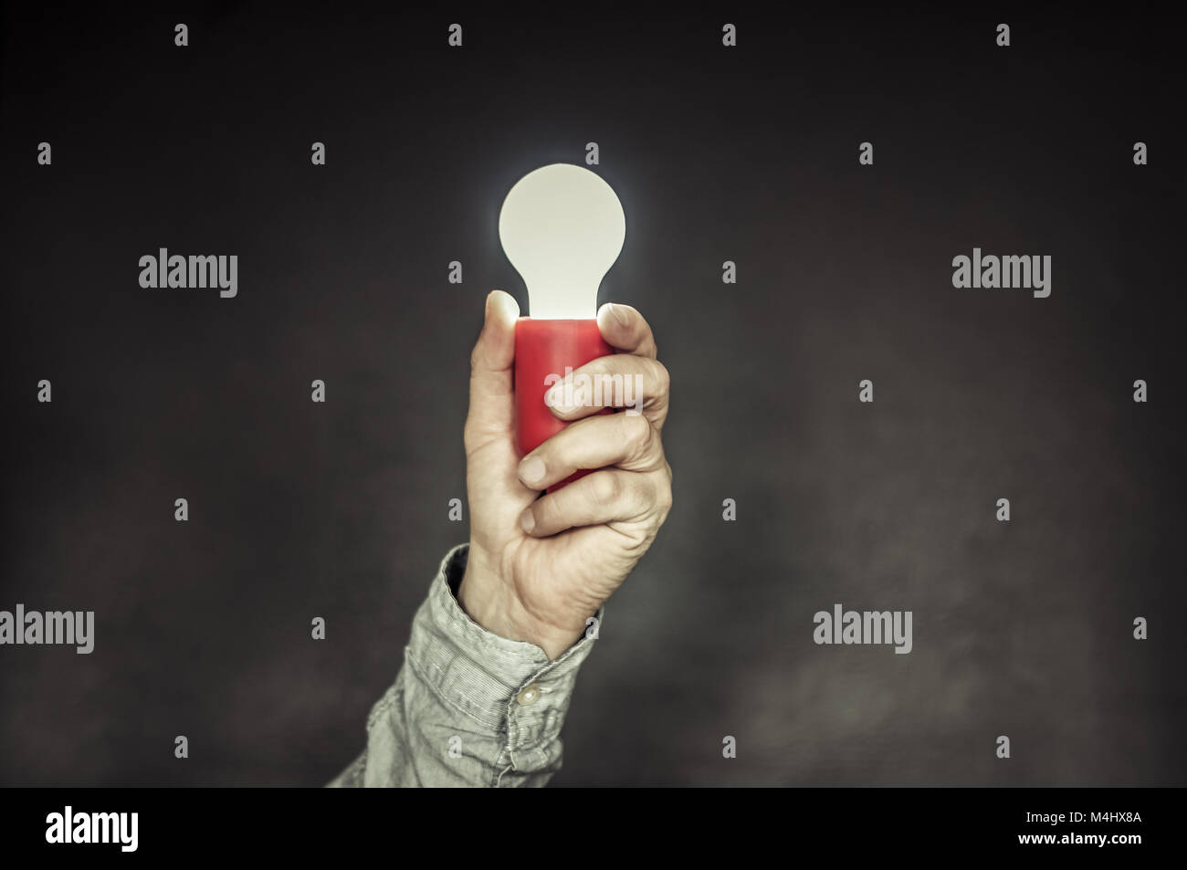 Hand with light bulb Stock Photo - Alamy