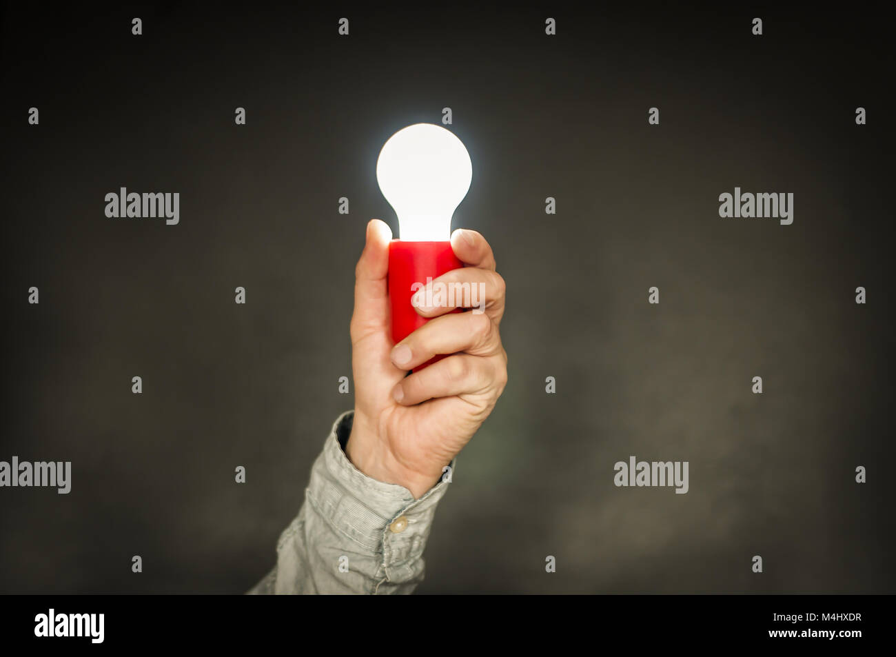 Hand with light bulb Stock Photo - Alamy