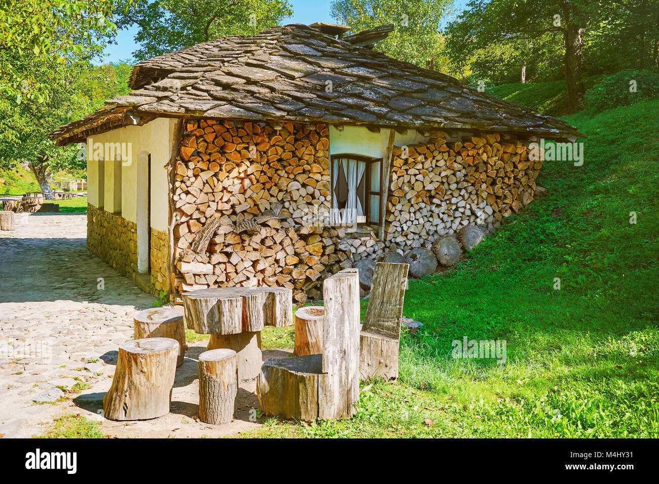 Small House with Stacked Firewood Stock Photo - Alamy