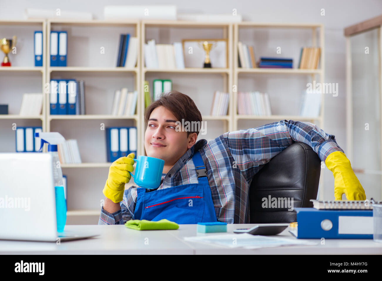 Male cleaner working in the office Stock Photo - Alamy