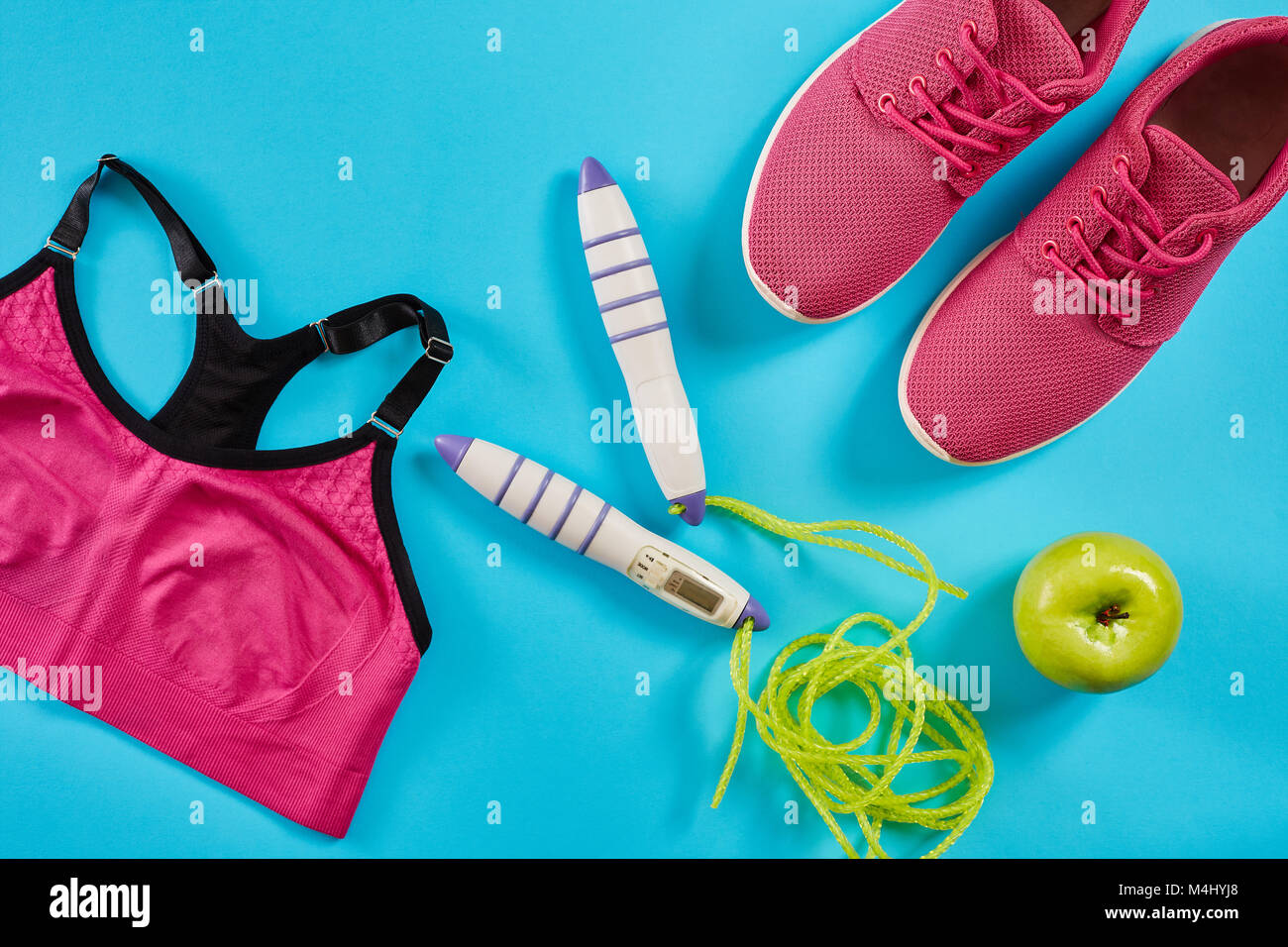 Flat lay of female sport equipments in pink color with jump rope and ...