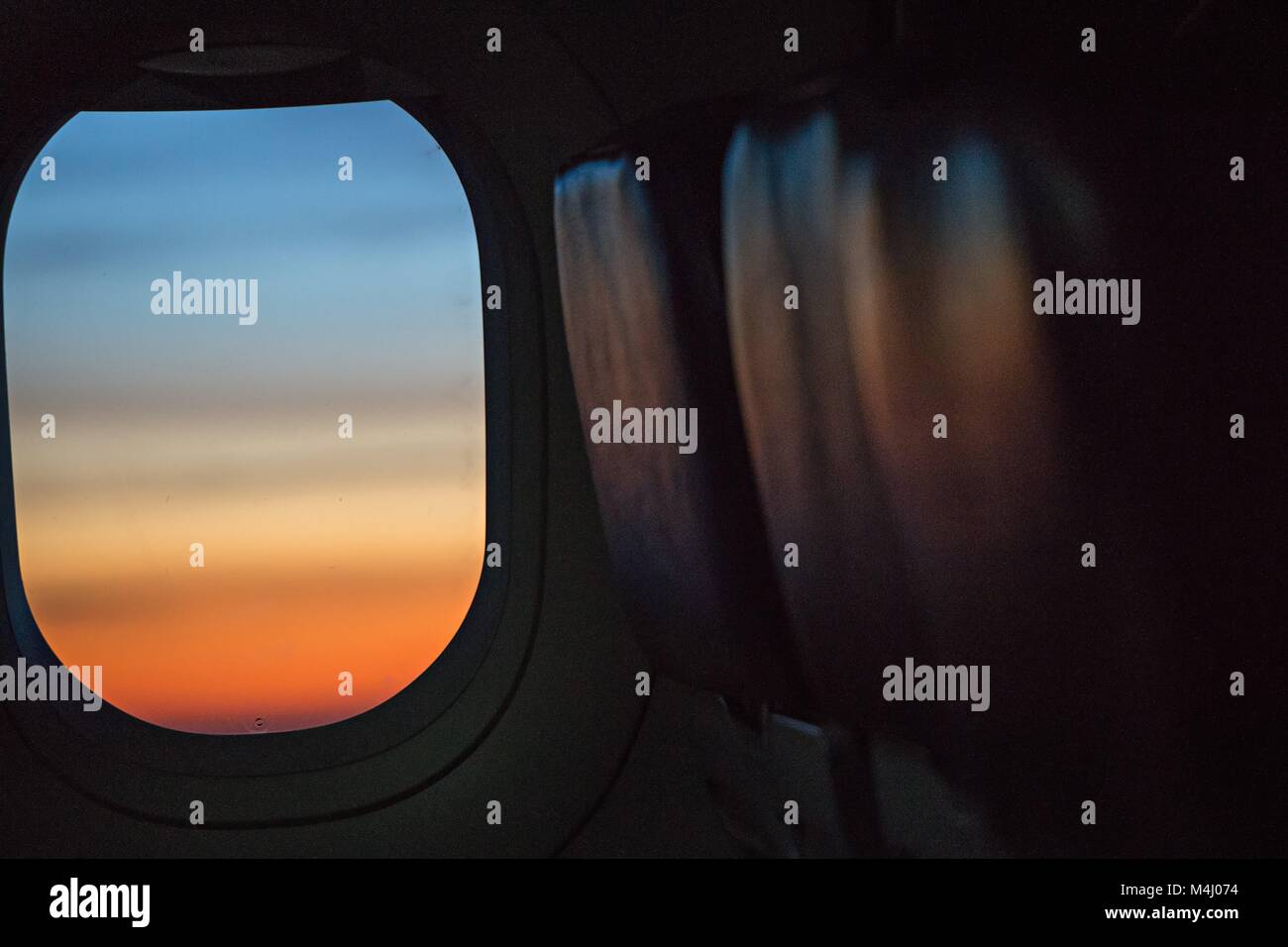 colorful sunrise in airplane window Stock Photo - Alamy
