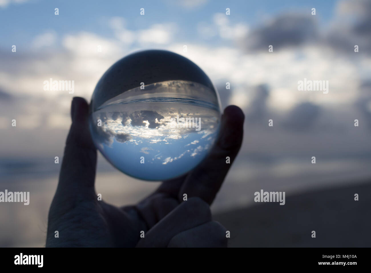 Holding a glass ball Stock Photo - Alamy