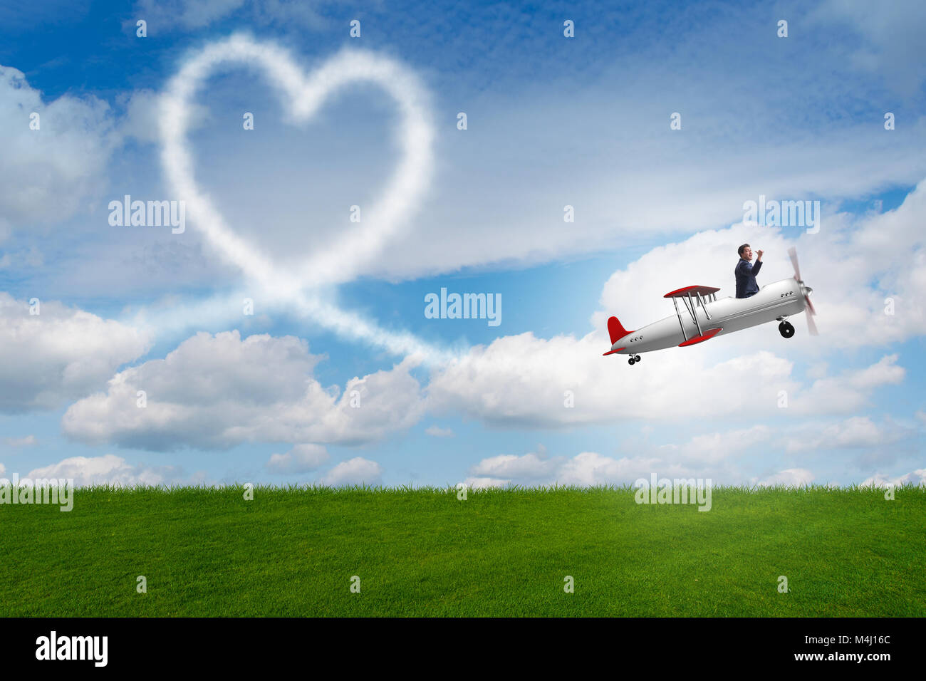 Man flying airplane and making heart shape Stock Photo - Alamy