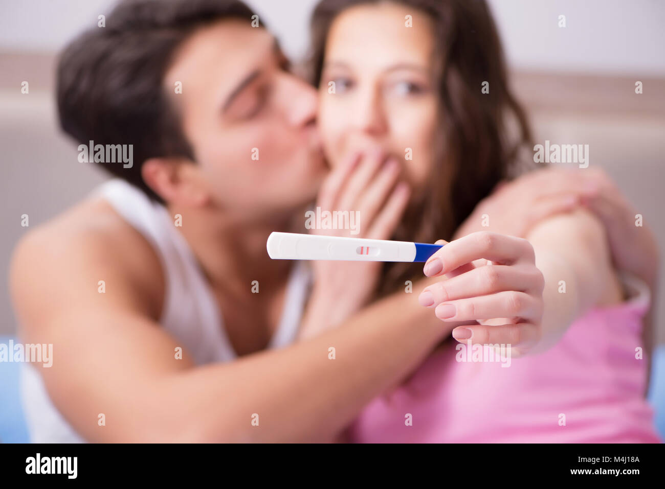Young family with pregnancy test results Stock Photo - Alamy