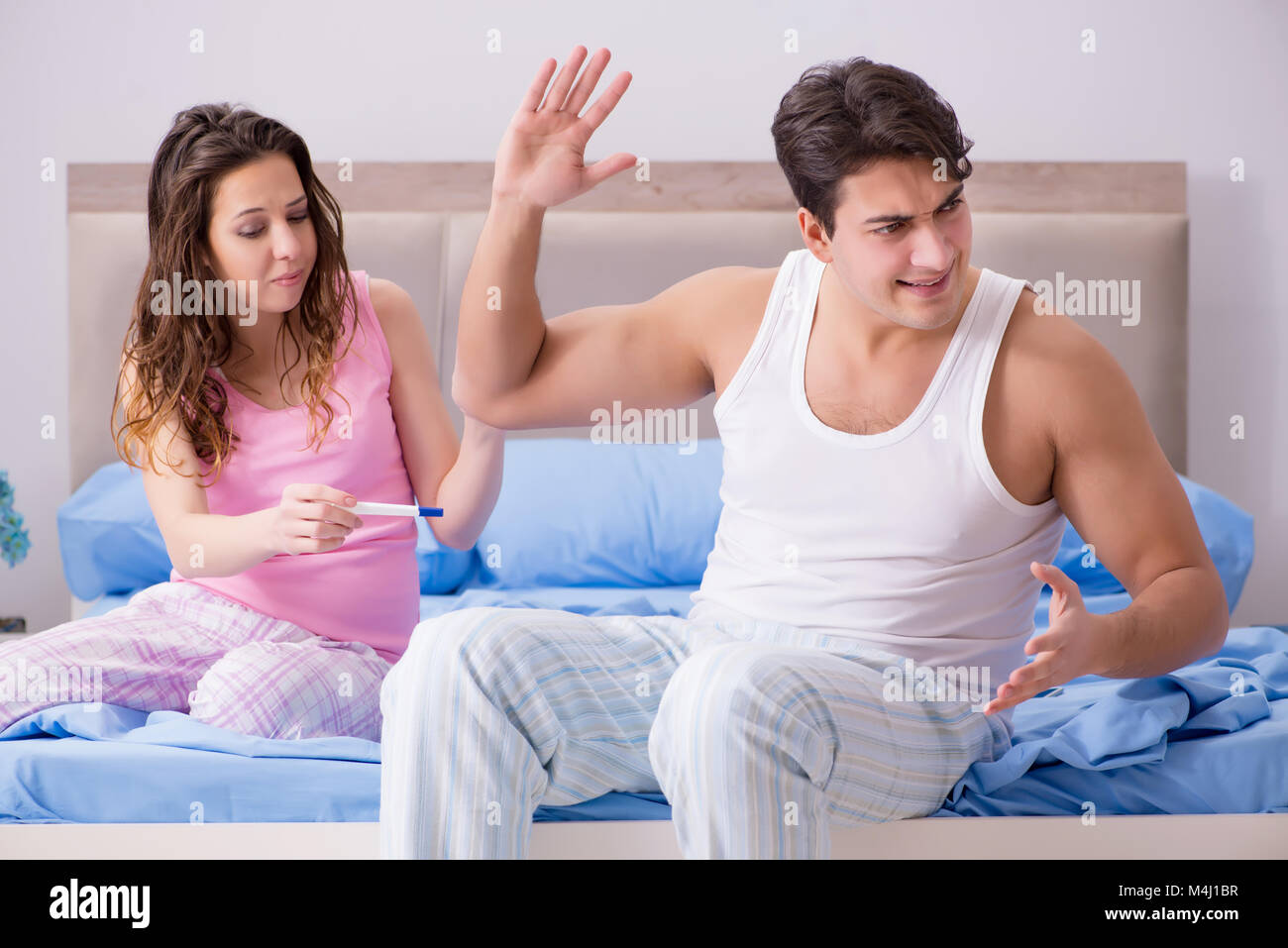 Young family with pregnancy test results Stock Photo - Alamy