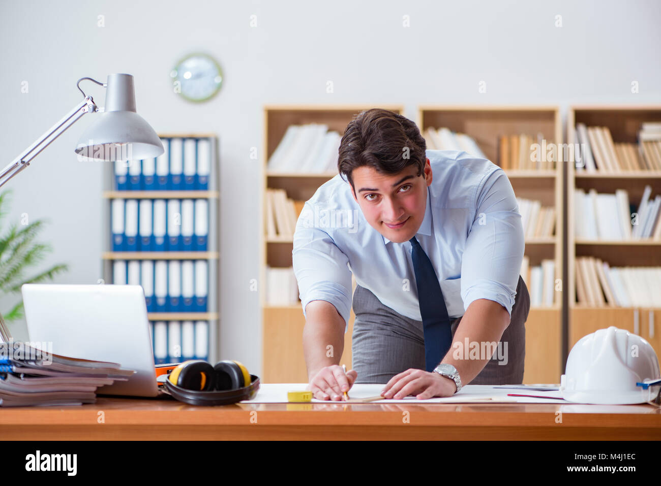 Engineer supervisor working on drawings in the office Stock Photo - Alamy