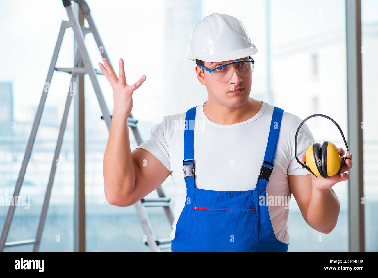 Young worker with noise cancelling headphones Stock Photo - Alamy