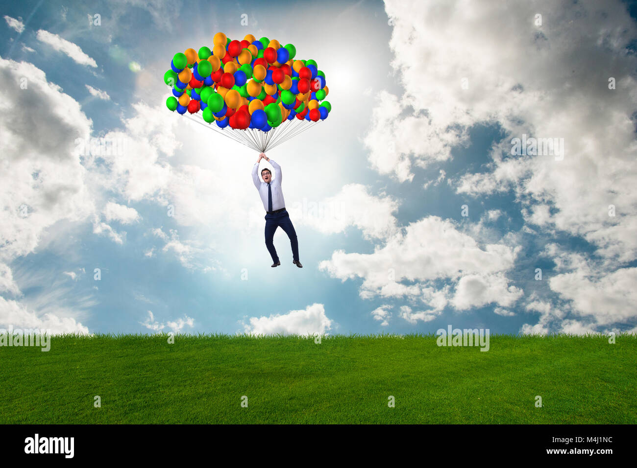 Businessman flying balloons on bright day Stock Photo - Alamy