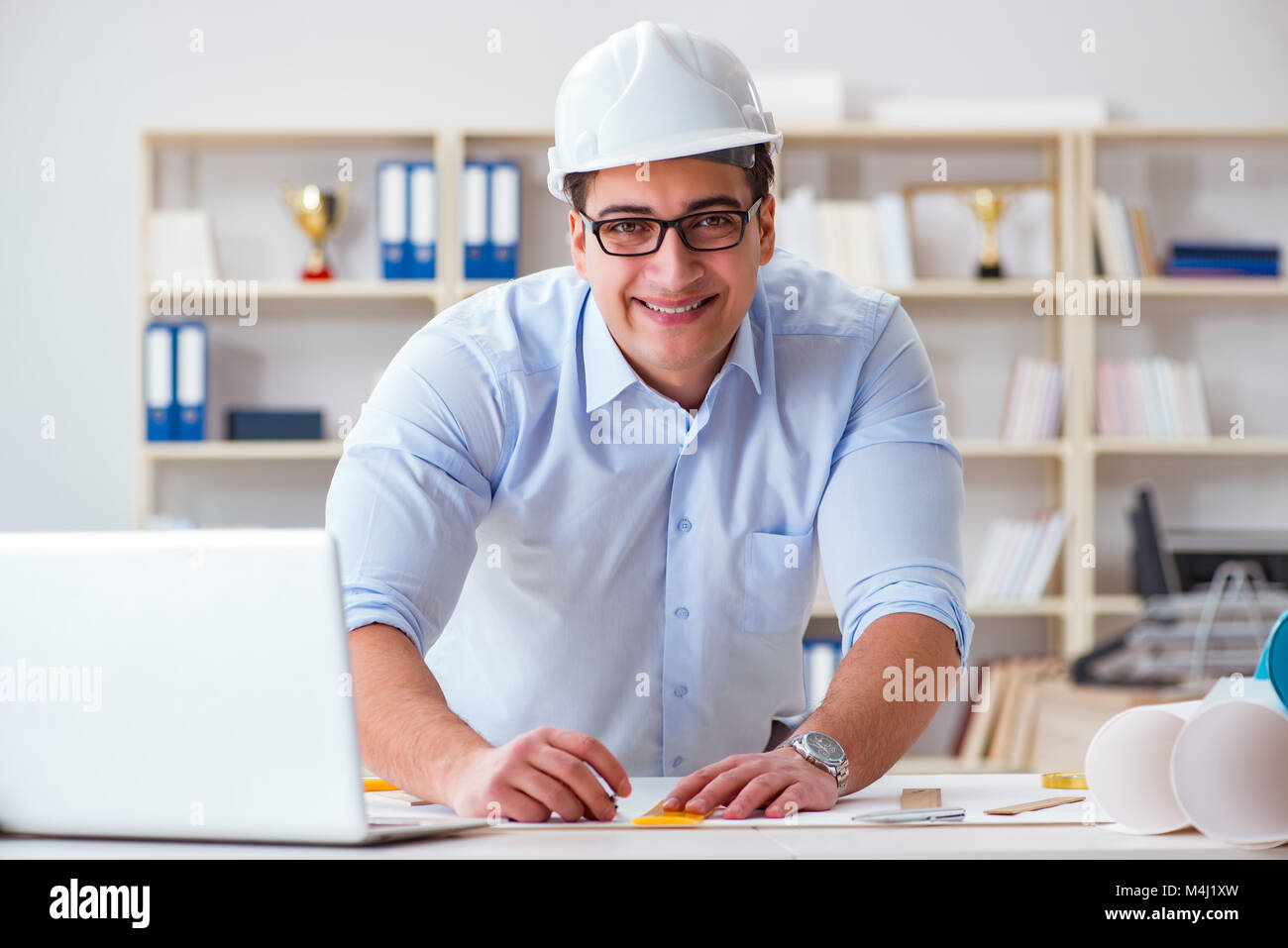 Male engineer working on drawings and blueprints Stock Photo - Alamy