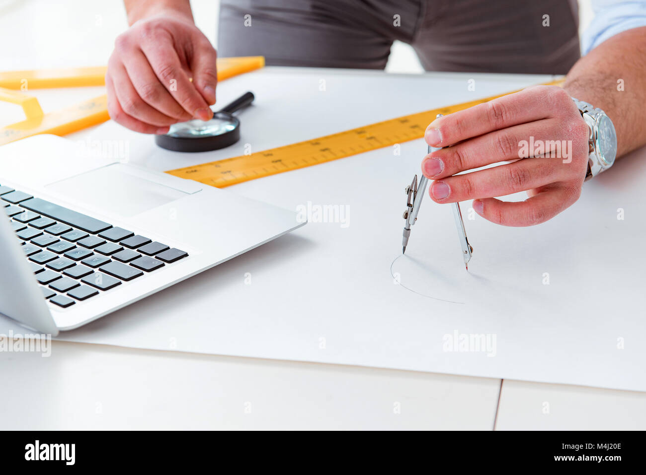 Male engineer working on drawings and blueprints Stock Photo - Alamy
