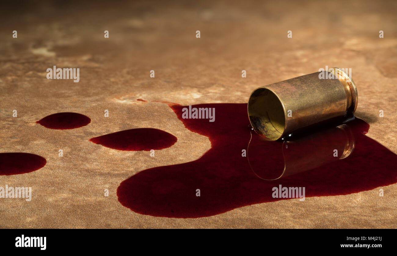 Beige floor tile with empty handgun brass laying on it with blood Stock ...