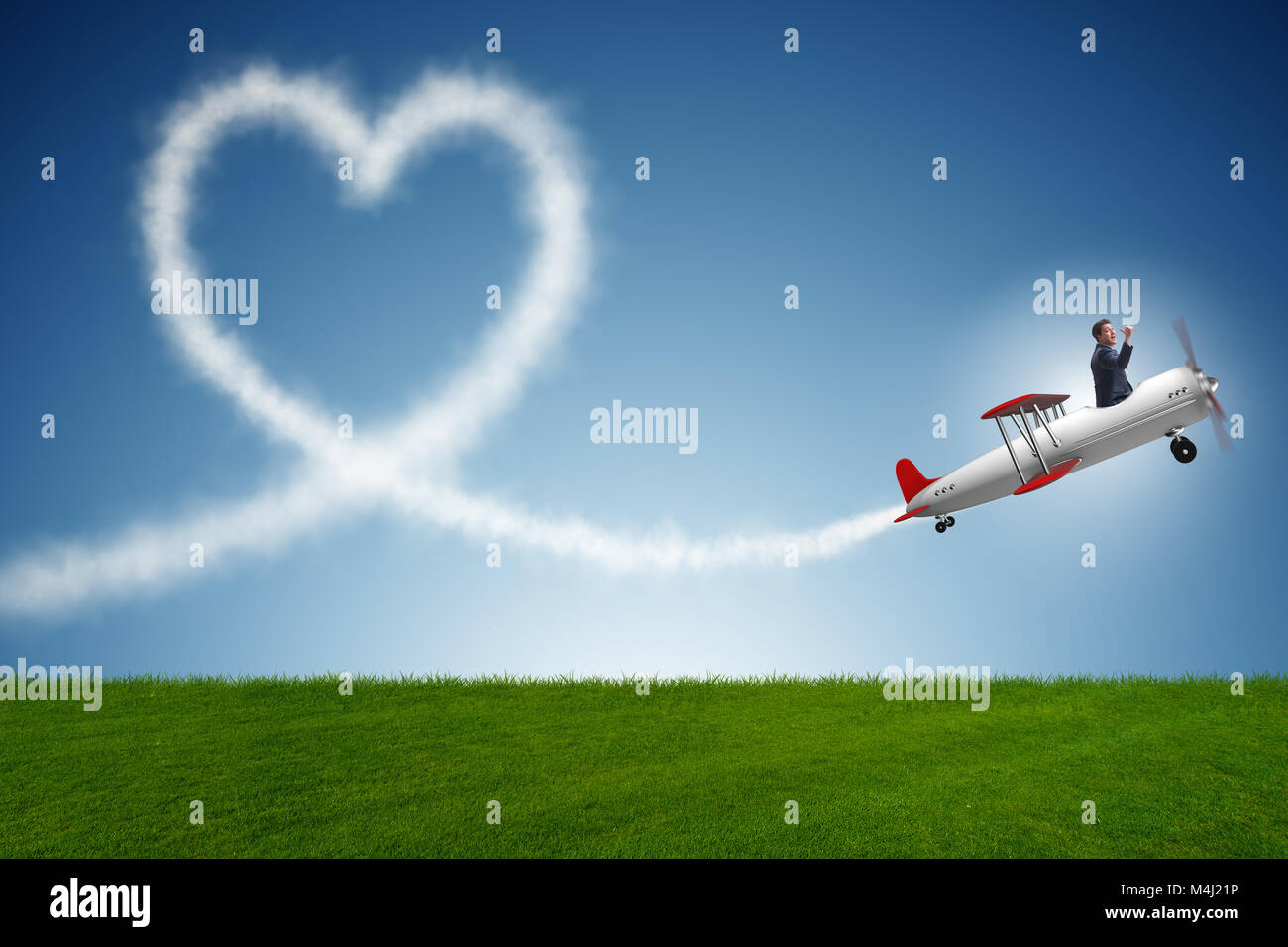 Man flying airplane and making heart shape Stock Photo - Alamy