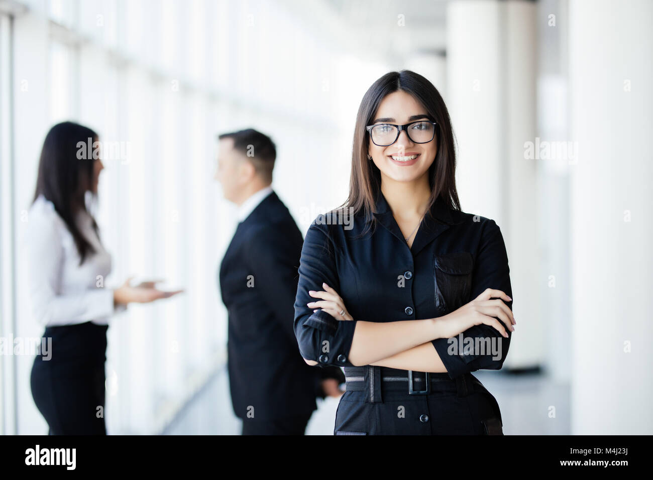 Business woman leading a corporate team in front Stock Photo - Alamy