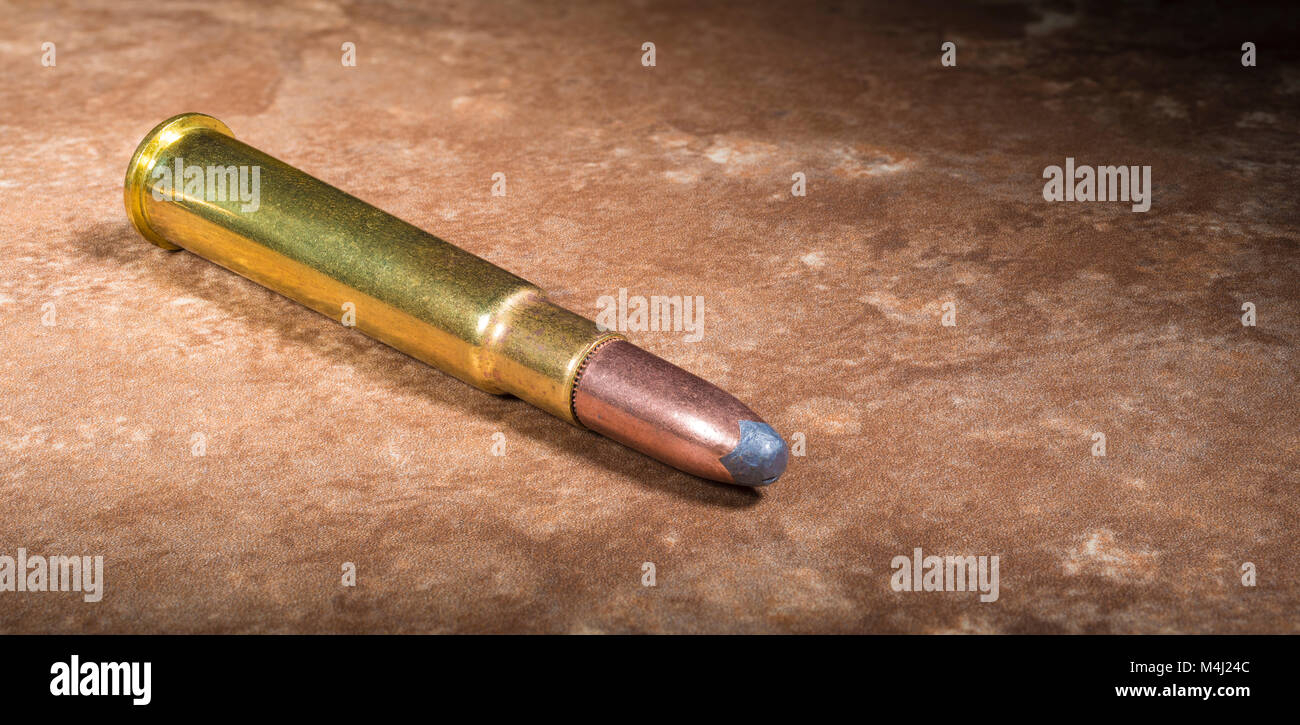 Cartridge that was used in 303 chambered rifles on a beige background ...