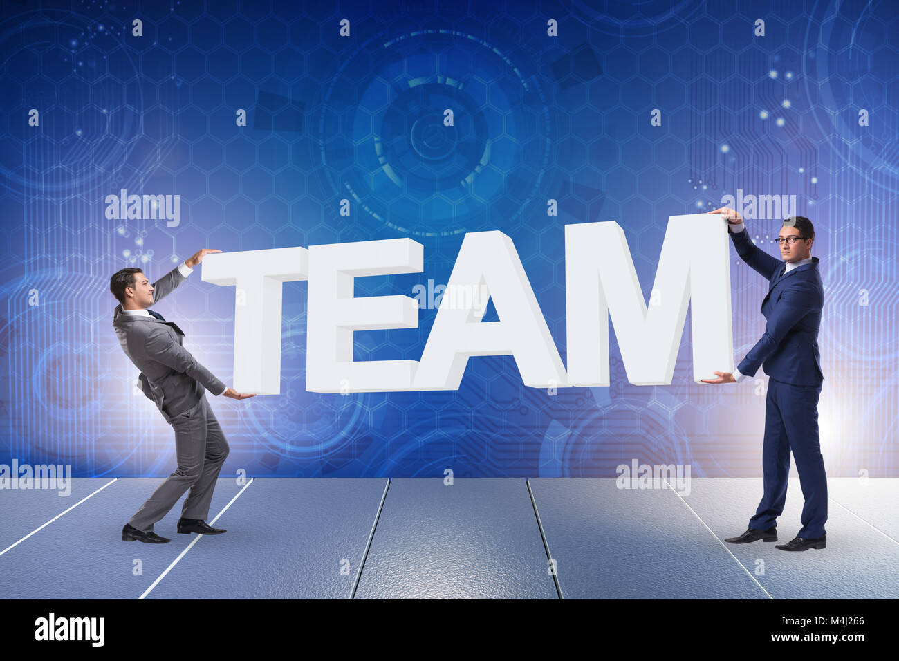 Businessmen holding word team in teamwork concept Stock Photo - Alamy