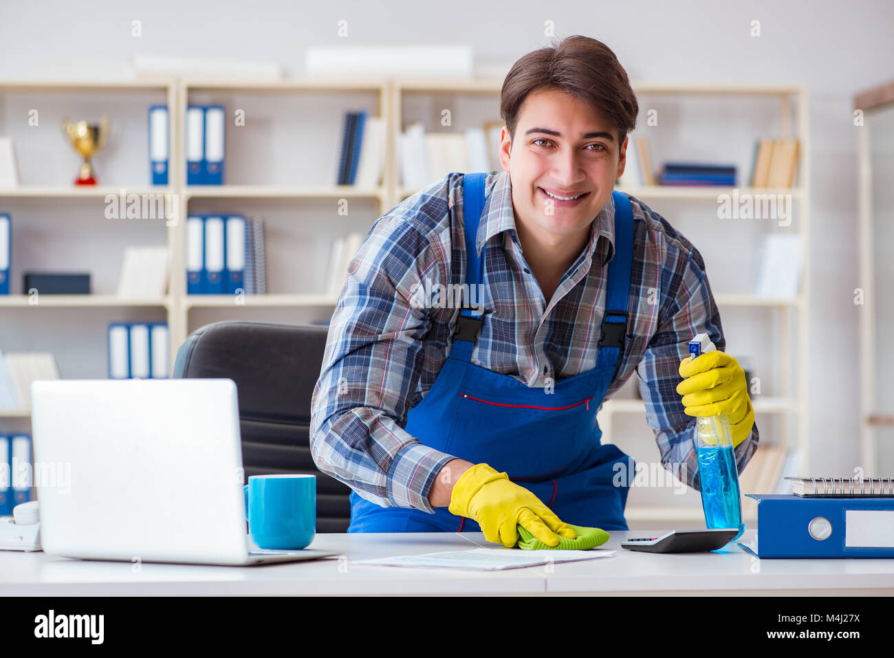 Male cleaner working in the office Stock Photo - Alamy