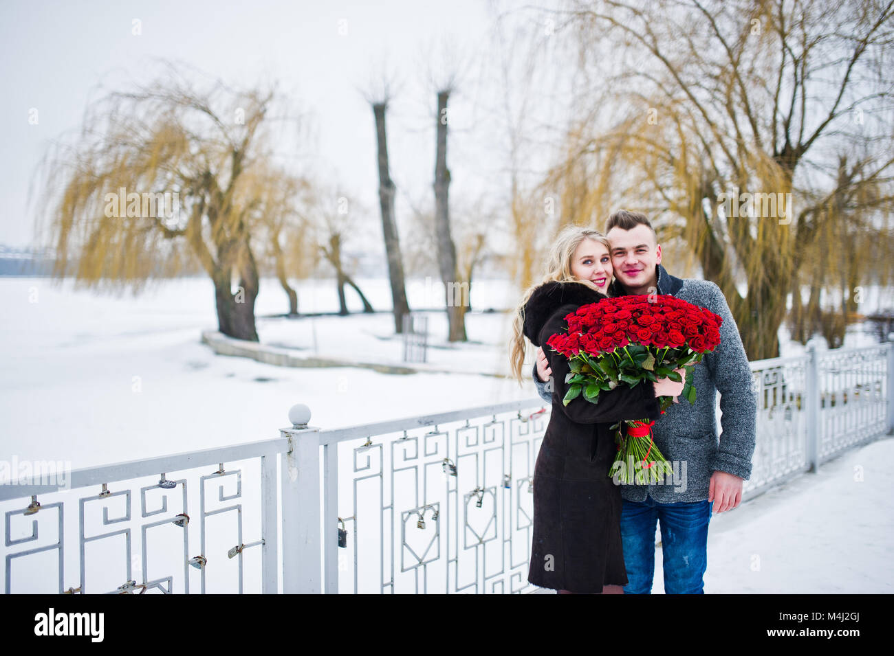 Married proposal with 101 rose at winter day. Loving couple Stock Photo ...