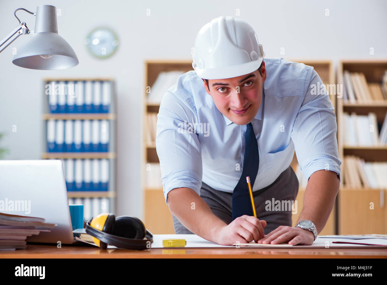 Engineer supervisor working on drawings in the office Stock Photo - Alamy