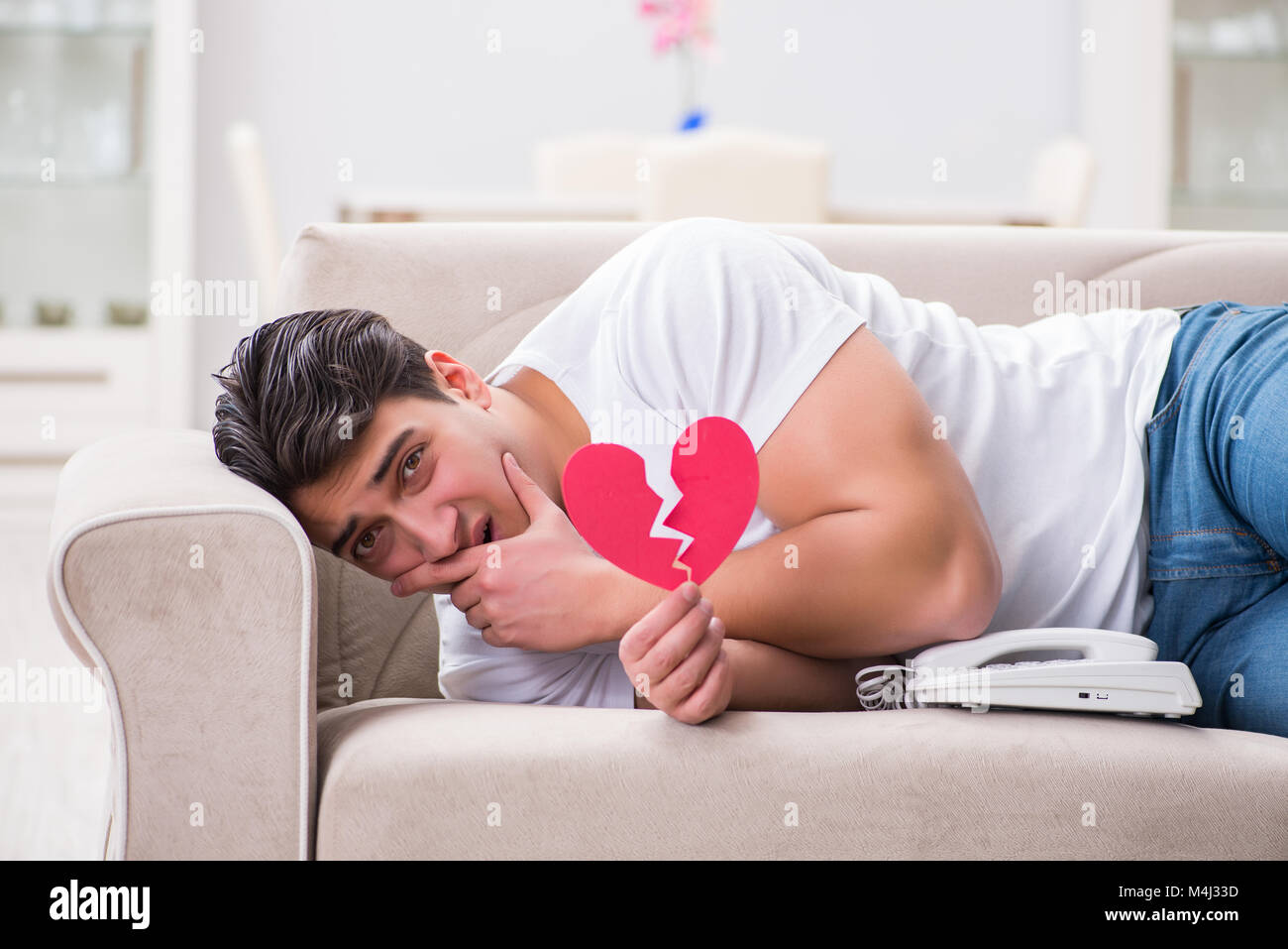 Young man in sad saint valentine concept Stock Photo - Alamy