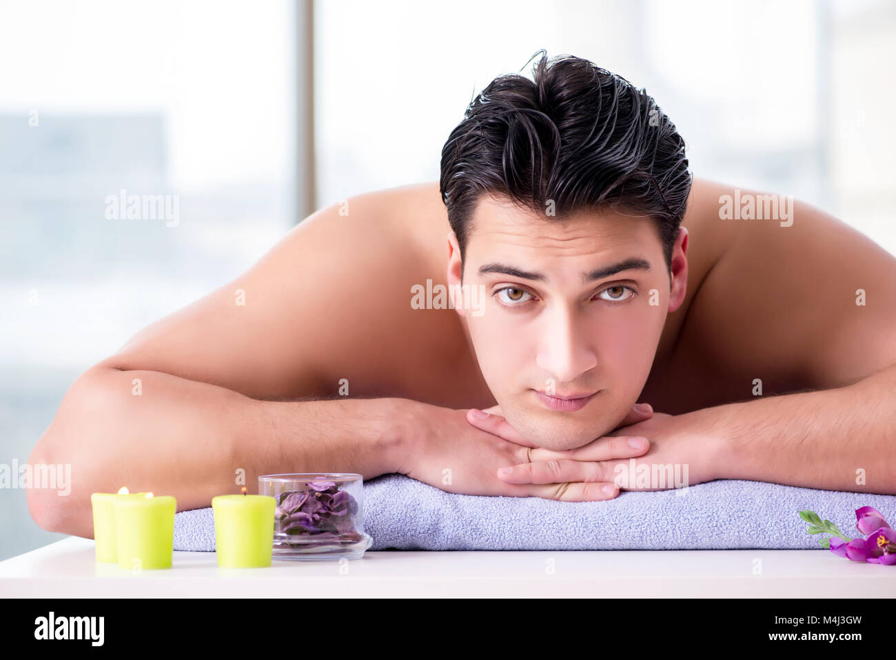 Handsome man in spa massage concept Stock Photo - Alamy