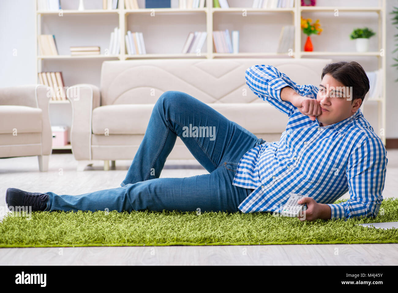 Tired man laying on the floor at home hi-res stock photography and ...