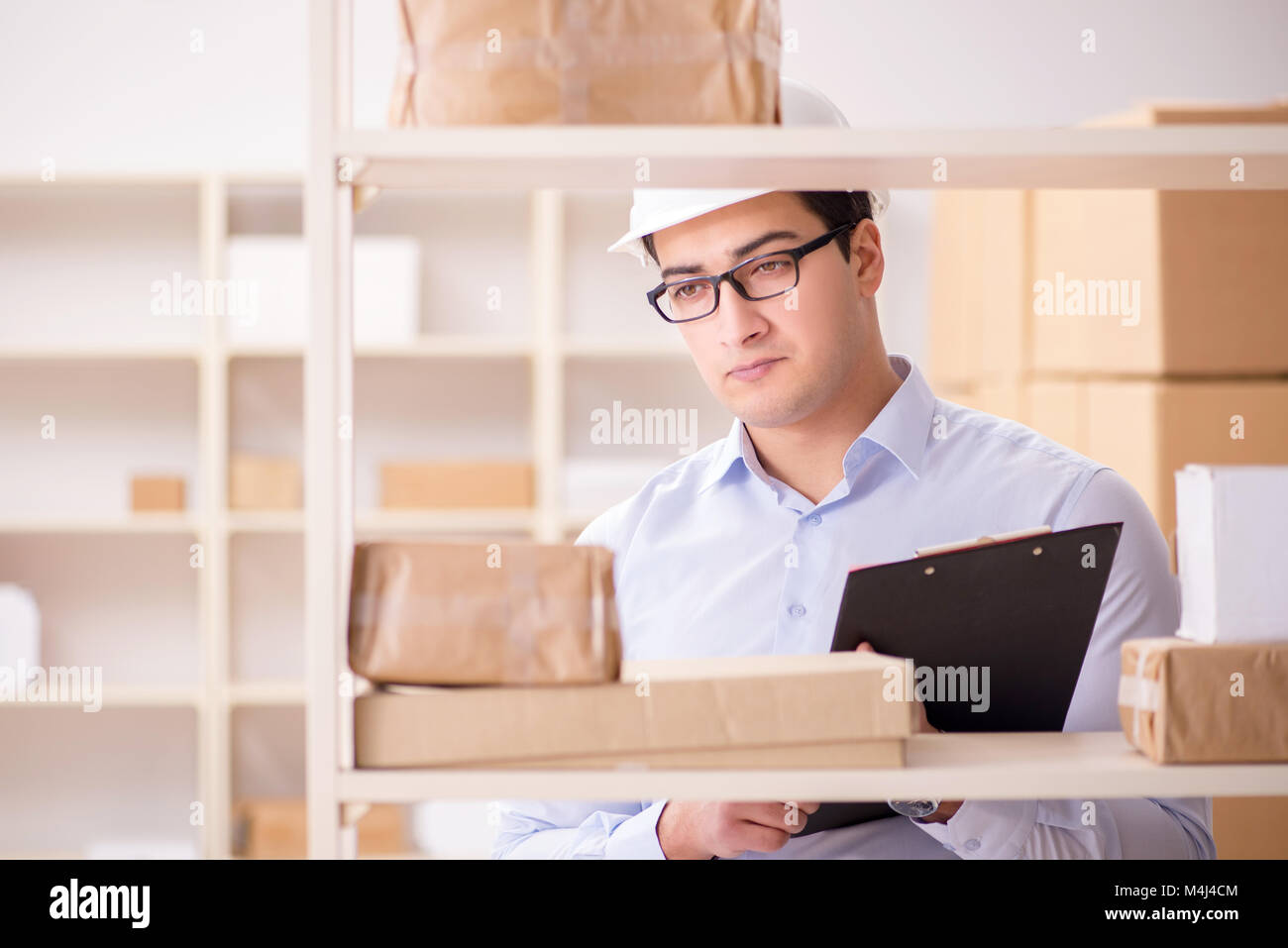 Man working in postal parcel delivery service office Stock Photo - Alamy
