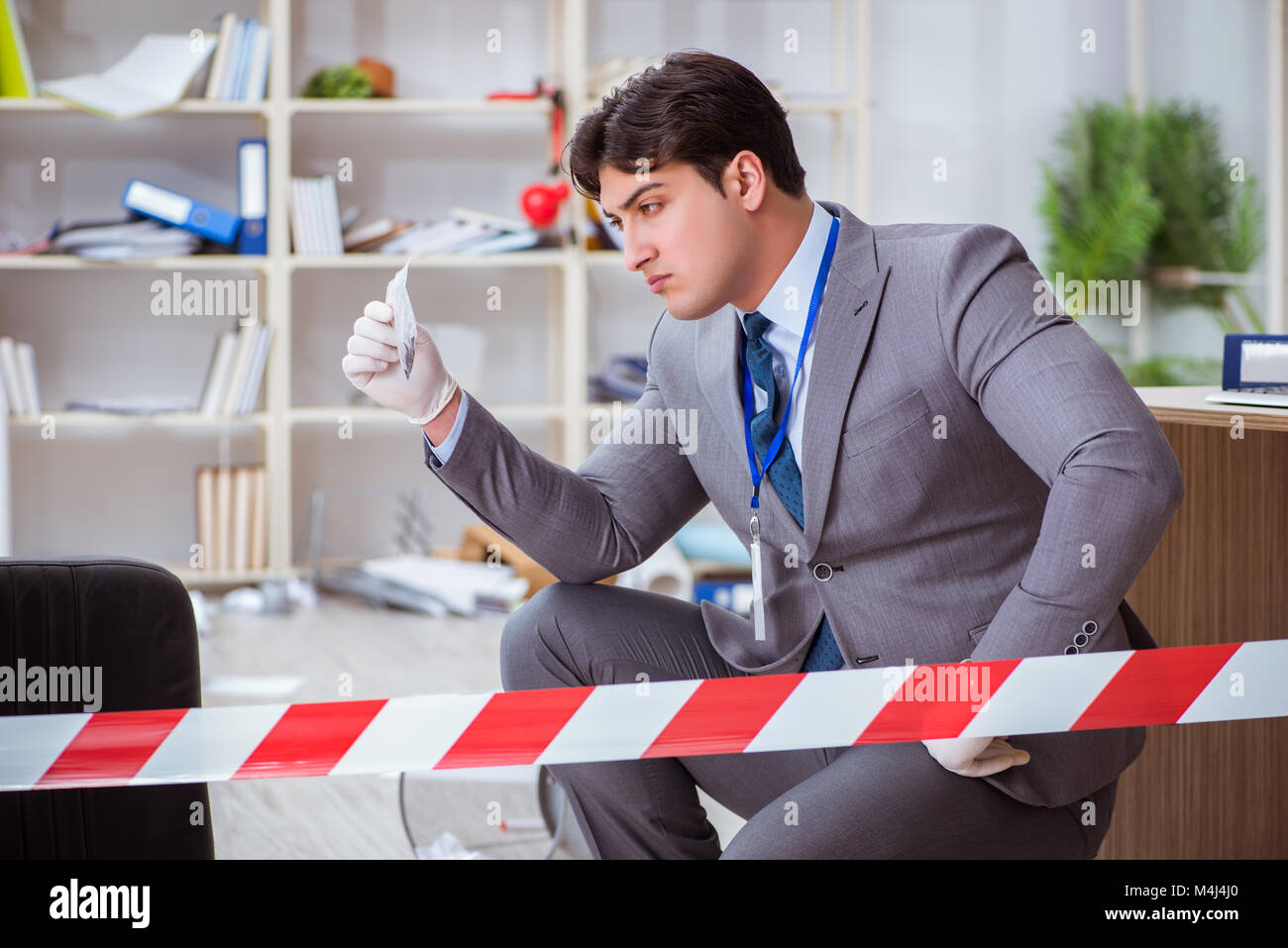 Young man during crime investigation in office Stock Photo - Alamy