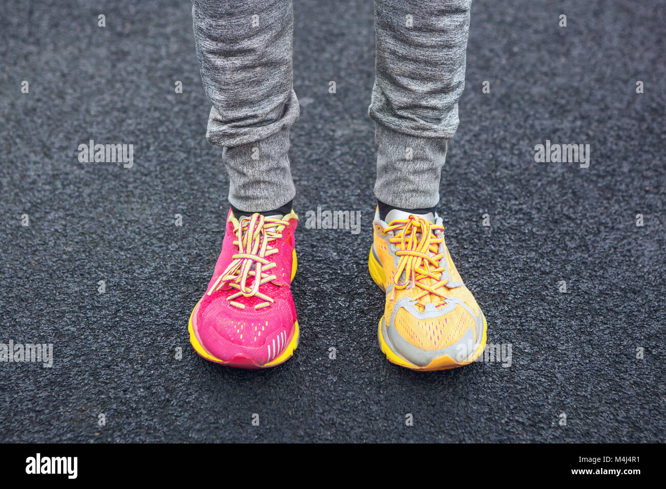 Which one should I choose? Legs in multi-colored running shoes Stock ...