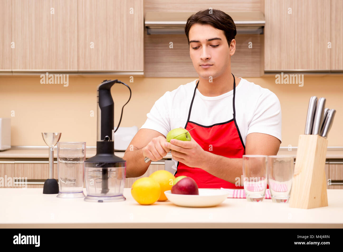 Handsome man working at the kitchen Stock Photo - Alamy