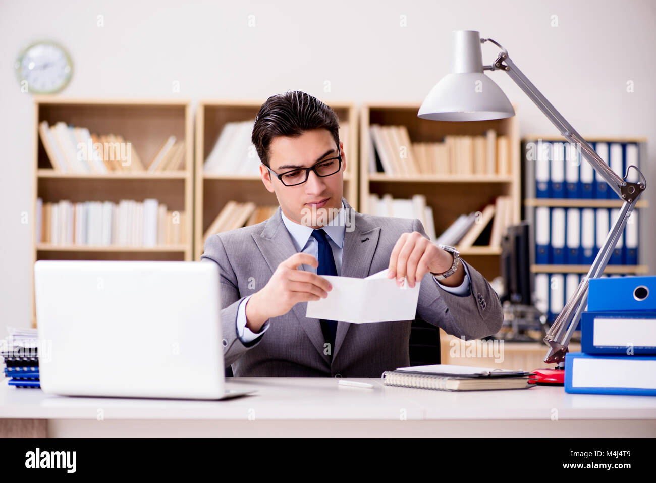 Businessman receiving letter envelope in office Stock Photo - Alamy