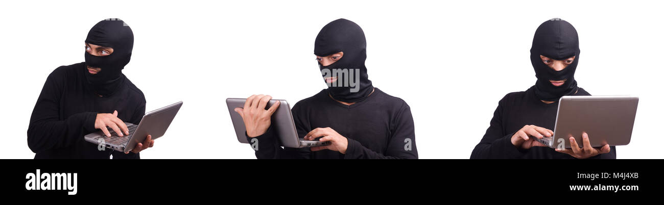Hacker with computer wearing balaclava Stock Photo - Alamy