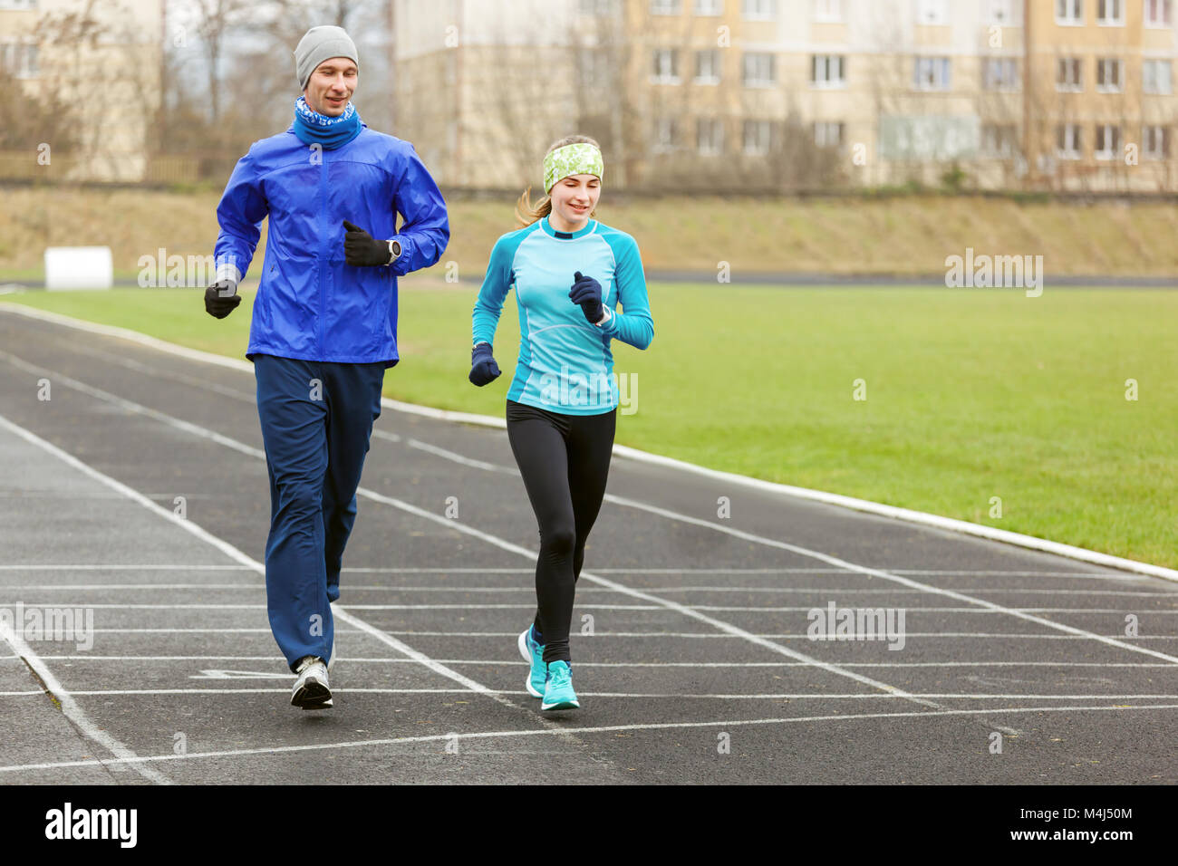 Young people running around the stadium in the morning Stock Photo - Alamy