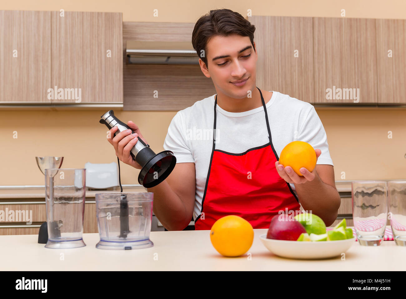 Handsome man working at the kitchen Stock Photo - Alamy