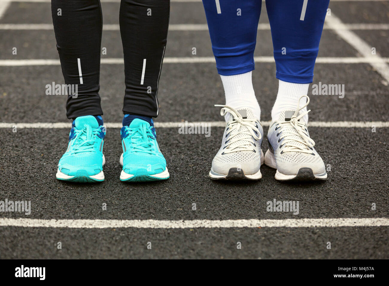 Front view of two runners in running shoes standing Stock Photo - Alamy