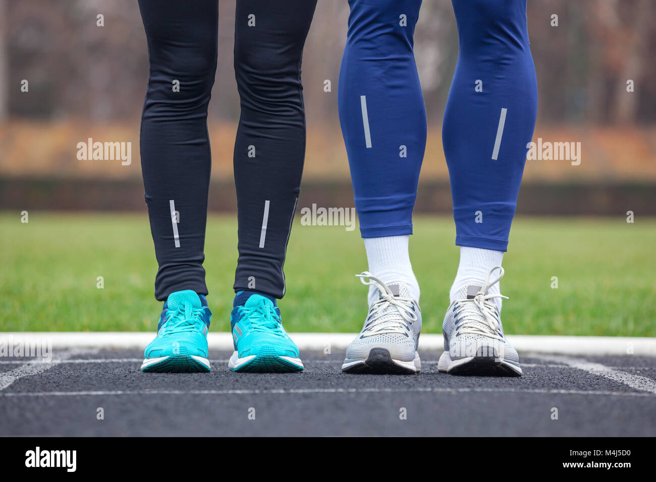 Front view of two runners in running shoes standing Stock Photo - Alamy