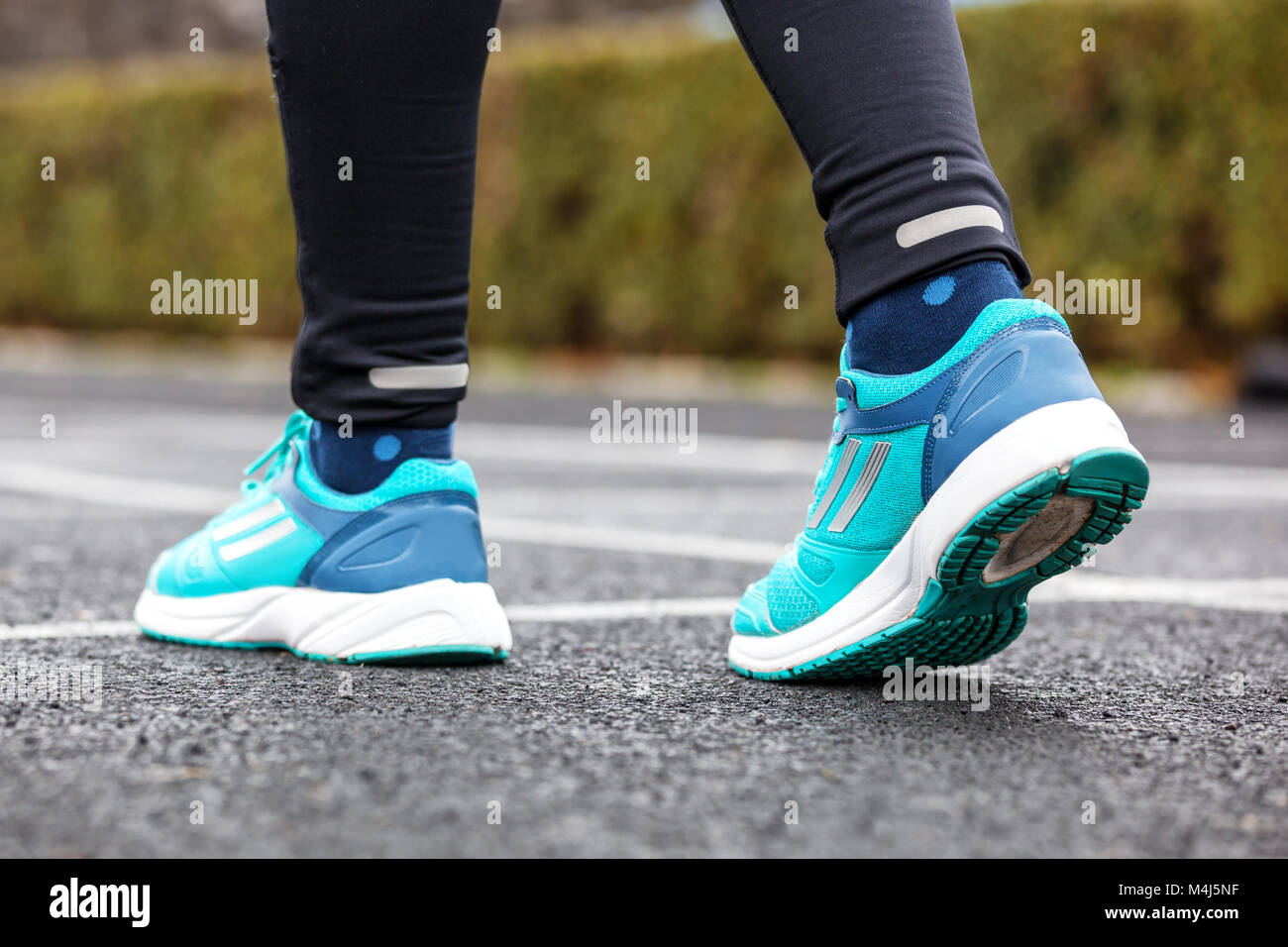 A cropped shot from behind of a woman's running shoes Stock Photo - Alamy