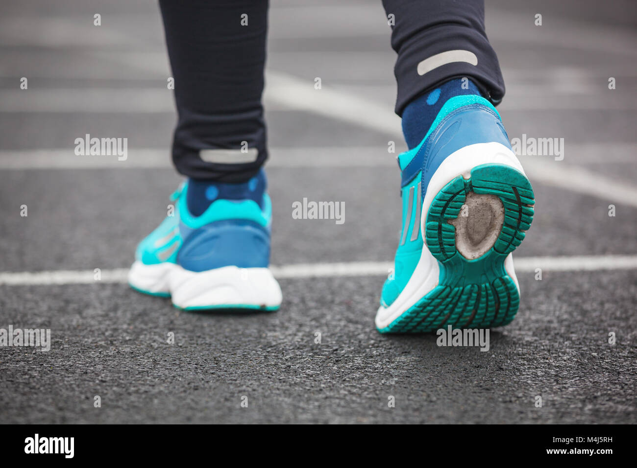 A cropped shot from behind of a woman's running shoes Stock Photo - Alamy