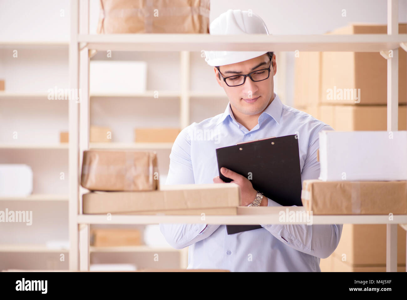 Man working in postal parcel delivery service office Stock Photo - Alamy